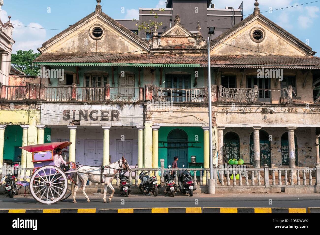 Mysore. Karnataka, India - August 2017: A man riding a wooden wheeled ...
