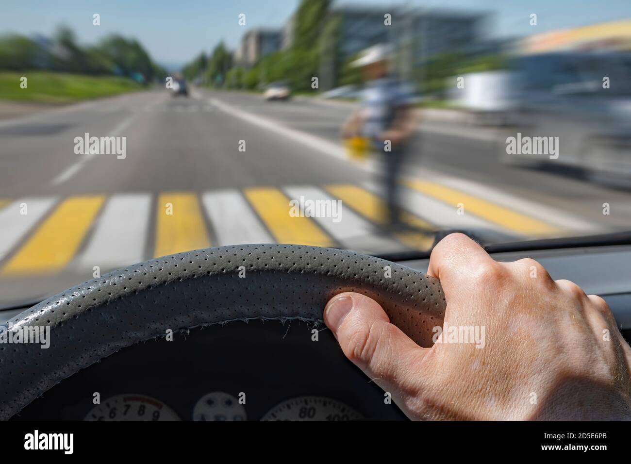 the driver hand on the steering wheel of a car moving at high speed ...