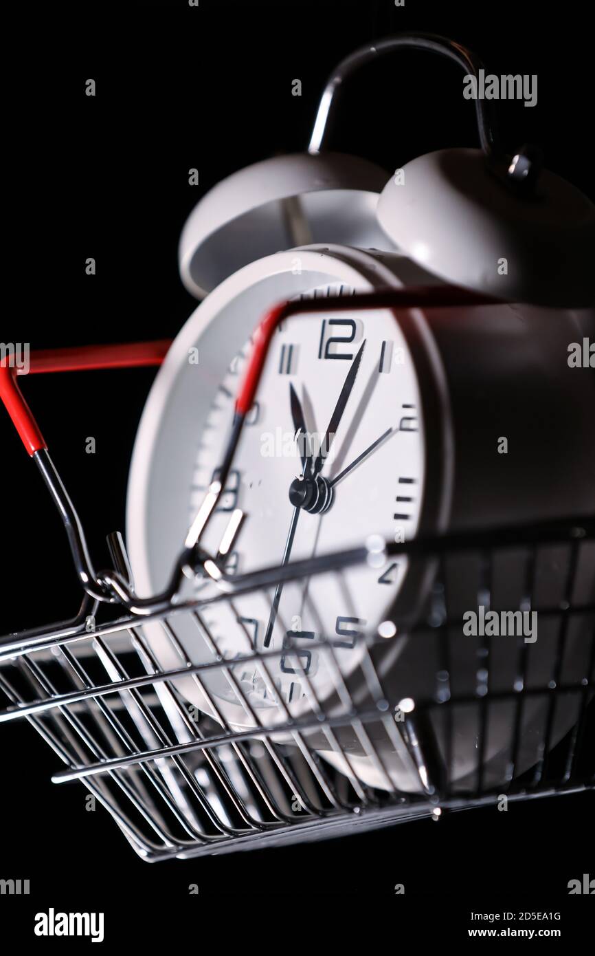 Red shopping basket with white retro alarm clock in it. Lose time. Buy ...