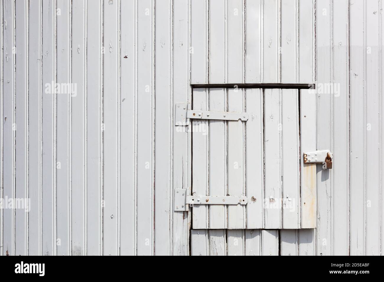 Vintage grey wooden plank wall background with hatch locked with a ...