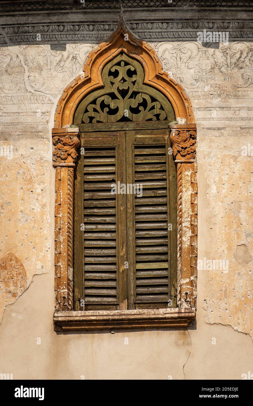 Close-up of an ancient window with arch in Venetian Gothic style ...