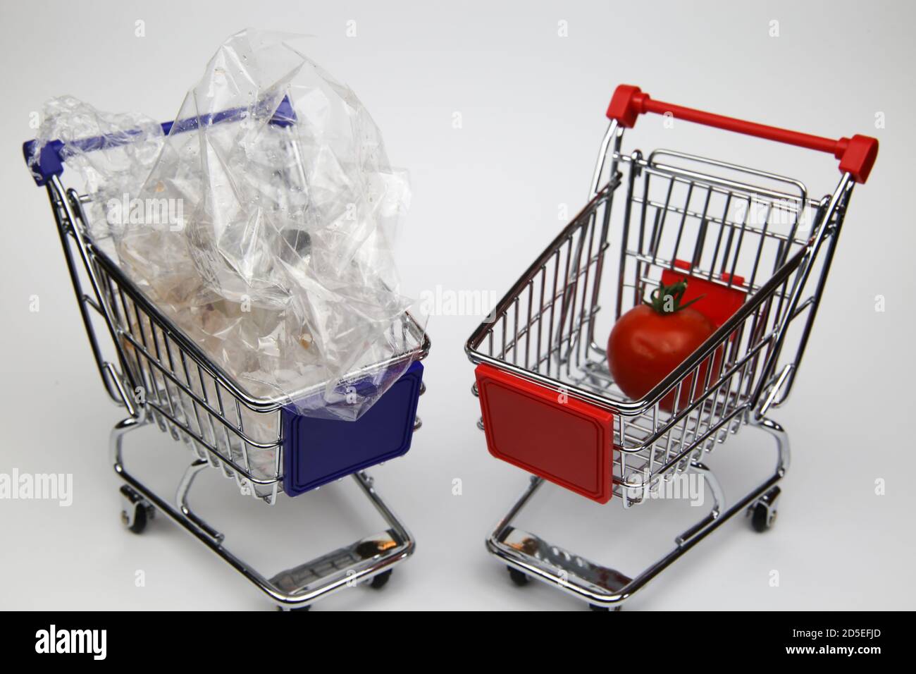 View on two isolated shopping cart with isolated tomato and too much ...