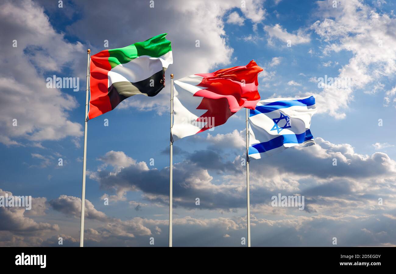 Flags of Israel, UAE and Bahrain together against the sky background ...