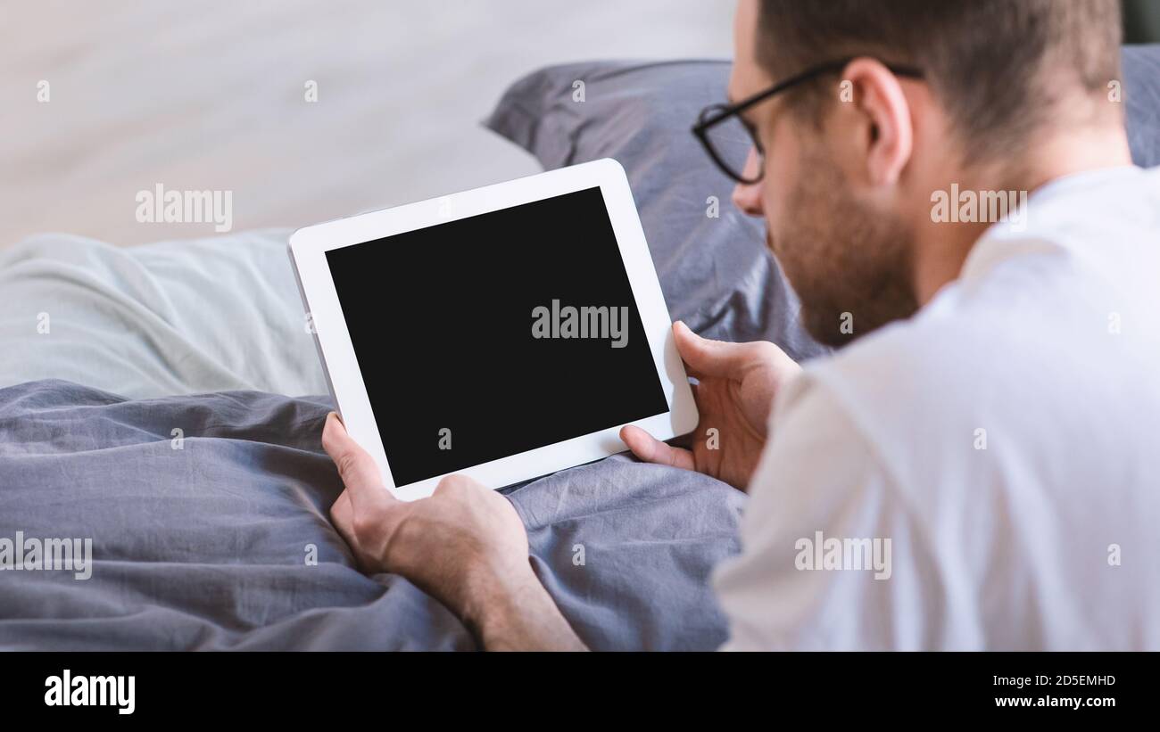Man using tablet lying hi-res stock photography and images - Alamy