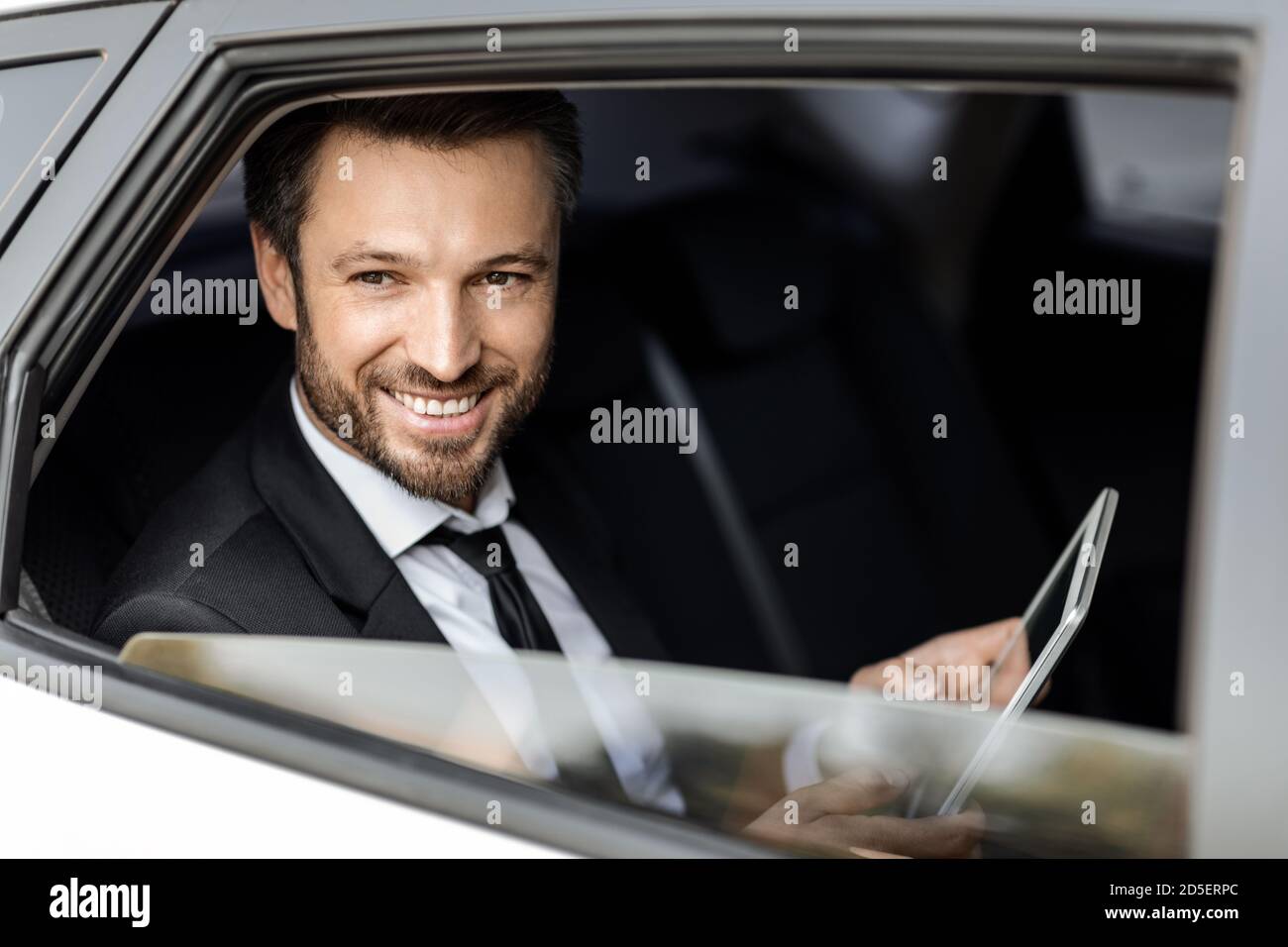 Person smiling in expensive car hi-res stock photography and images - Alamy