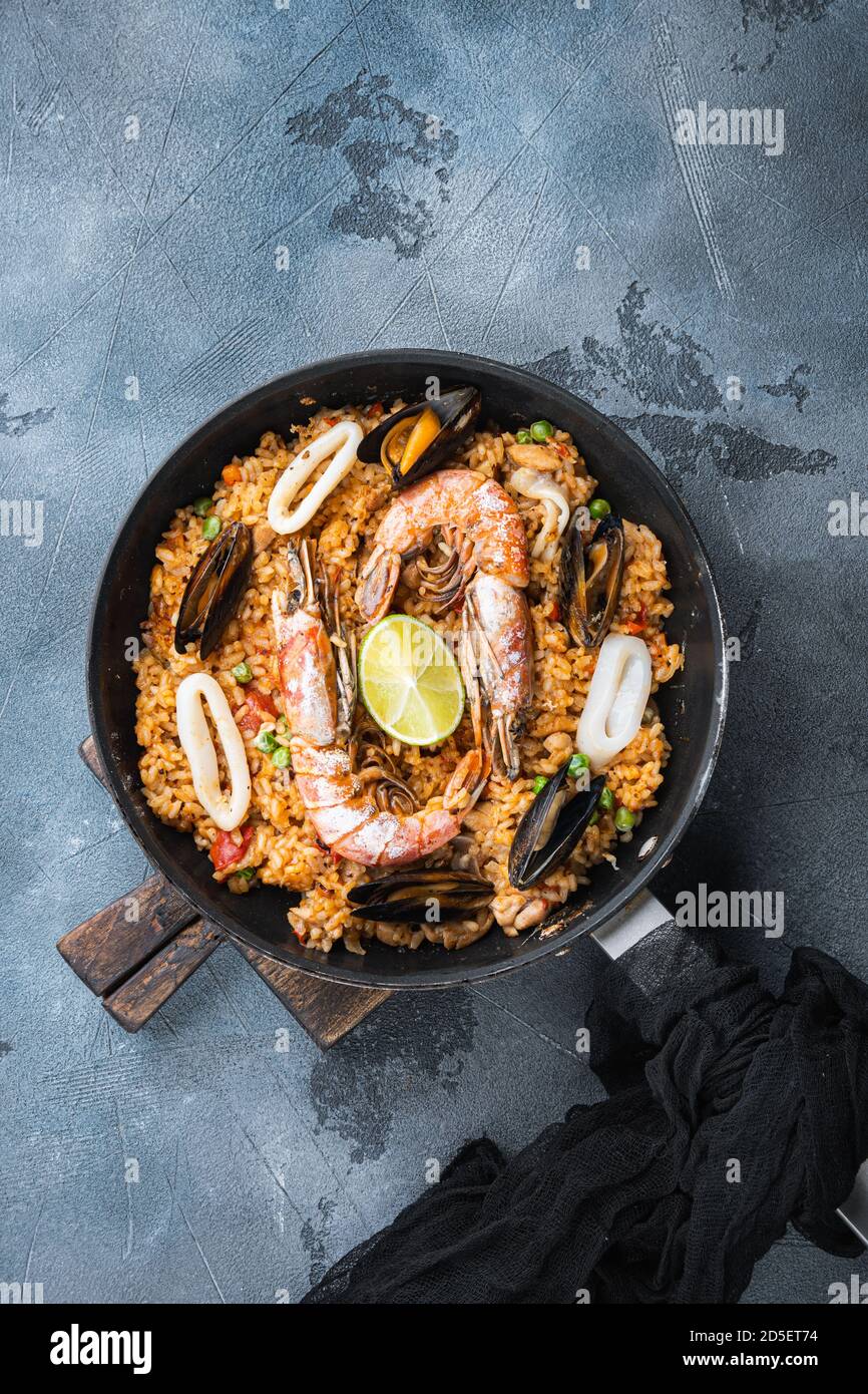 Homemade freshly prepared paella with chicken and seafood on grey ...