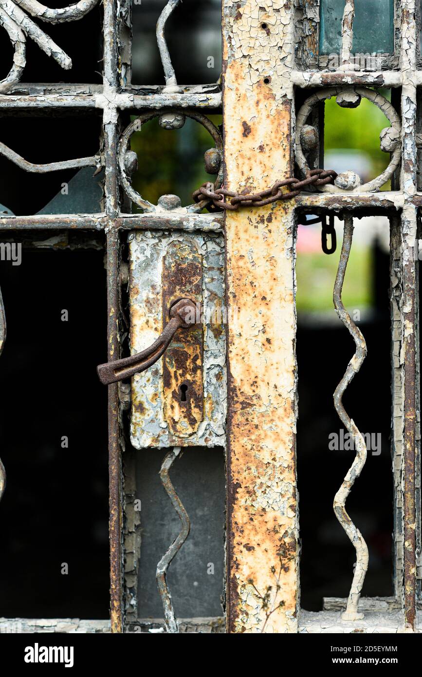 Old dilapidated metal gate with a rusty handle Stock Photo - Alamy