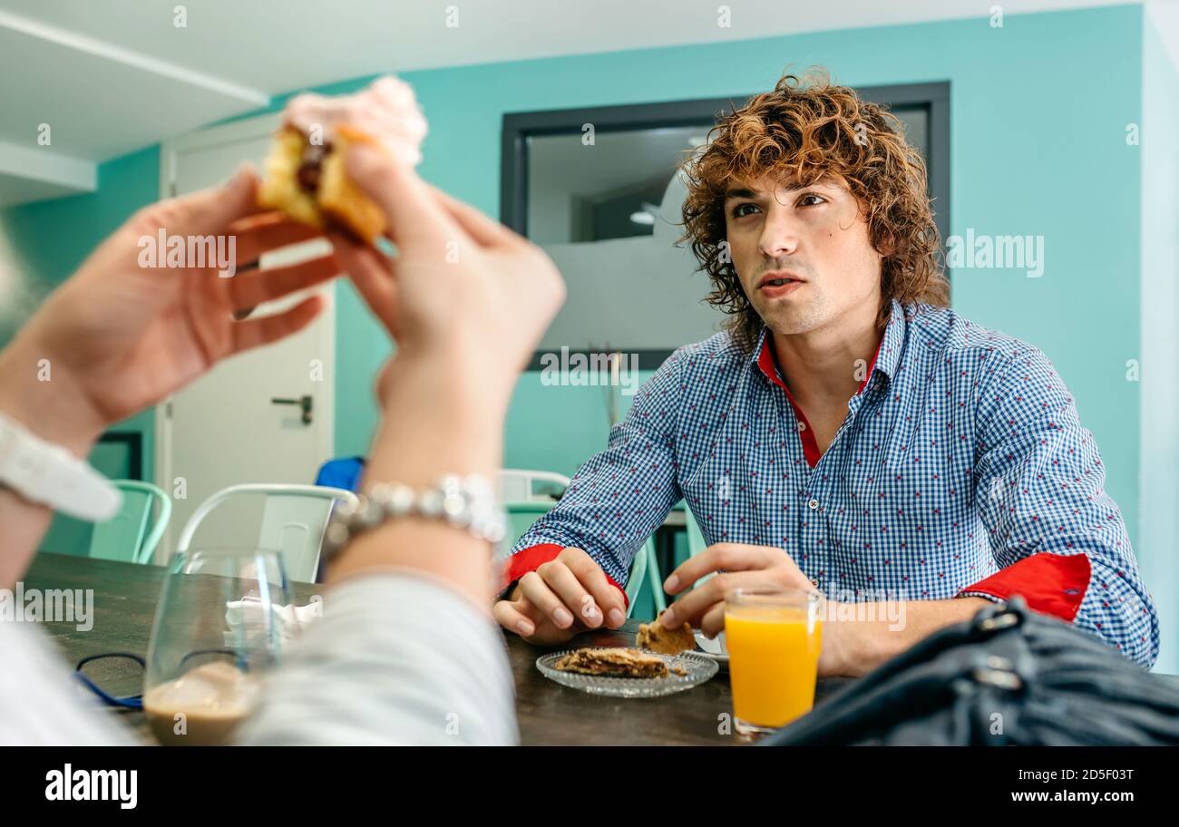 Young woman talking eating breakfast hi-res stock photography and ...
