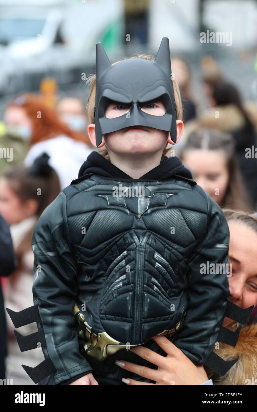 A Batman fan watches during the filming of The Batman taking place in ...