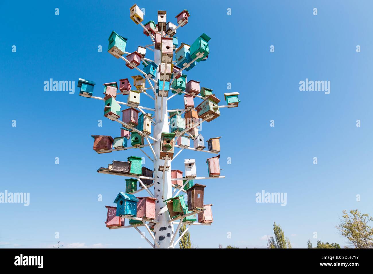 Birdhouse, bird house. Many wooden multi-colored houses on a decorative ...