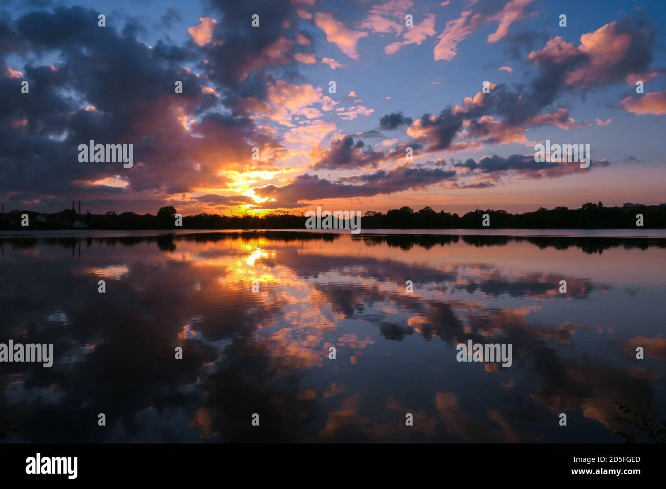 Amazing sunrise in rural scene. Symmetry of the sky in a lake at sunset ...