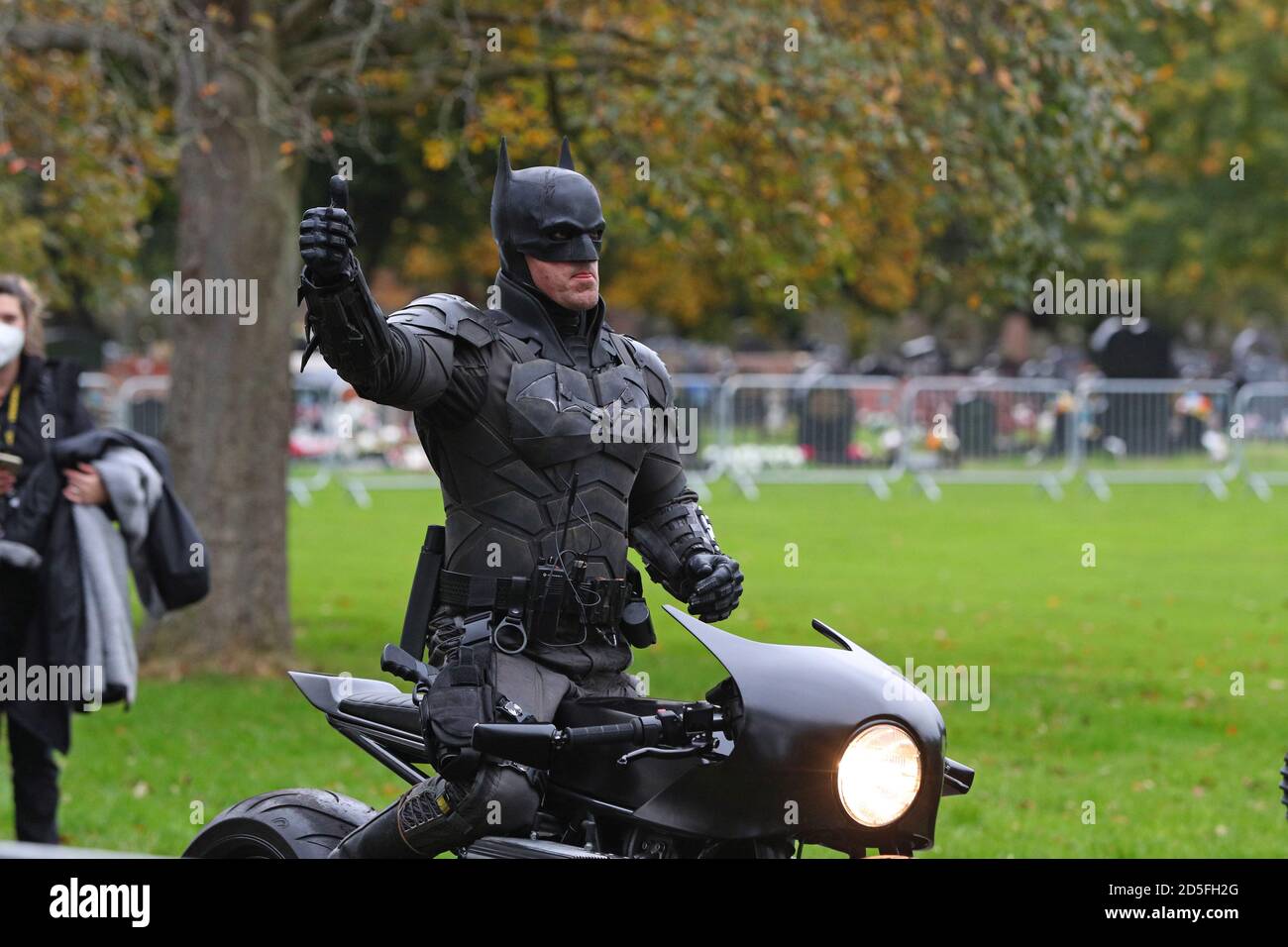 A man dressed as Batman greets fans during the filming of The Batman ...