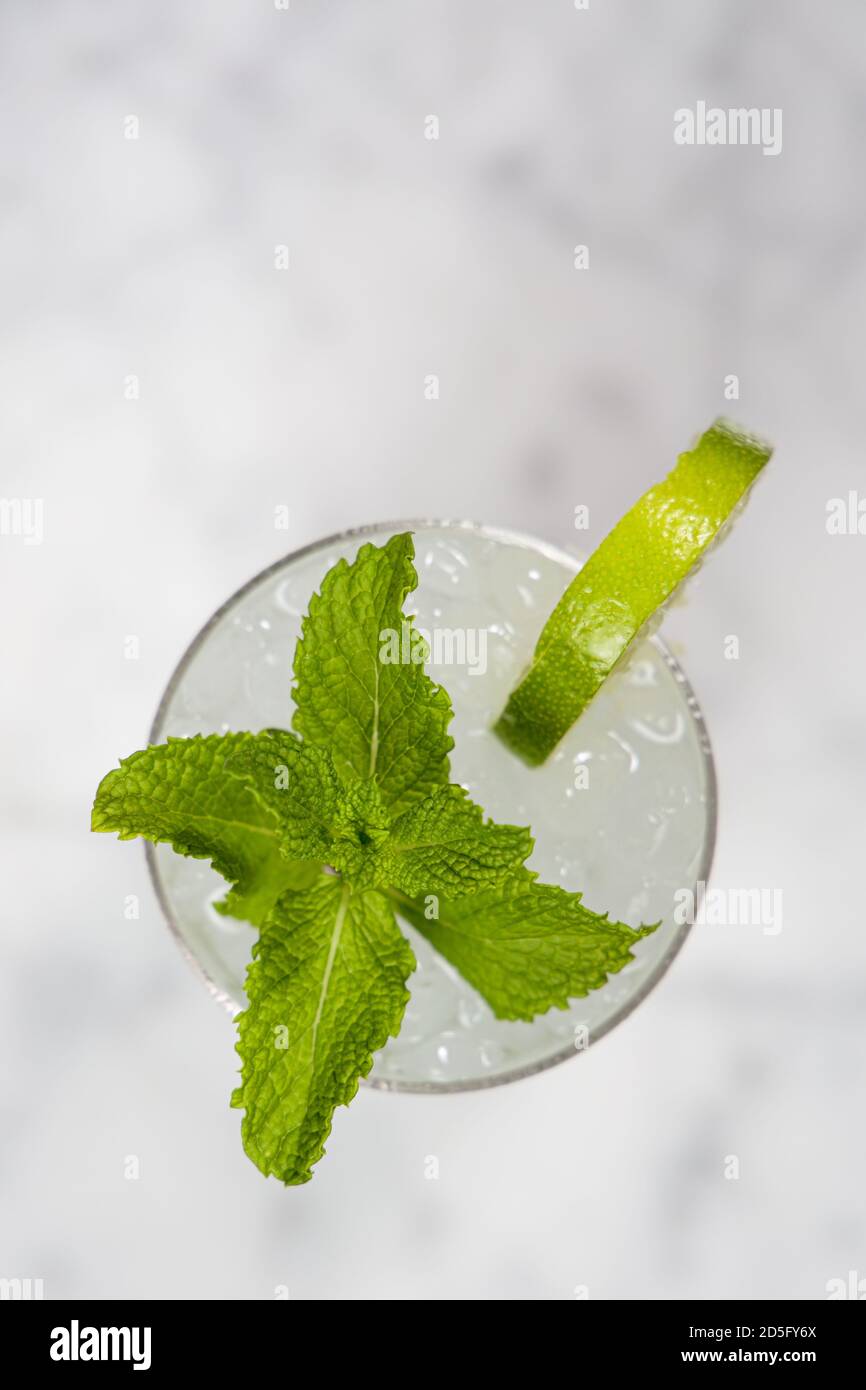 One refreshing mojito cocktail on a marble table. Top view Stock Photo ...