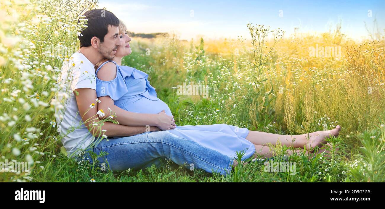 man hugs belly of a pregnant woman on nature. Selective focus. nature ...
