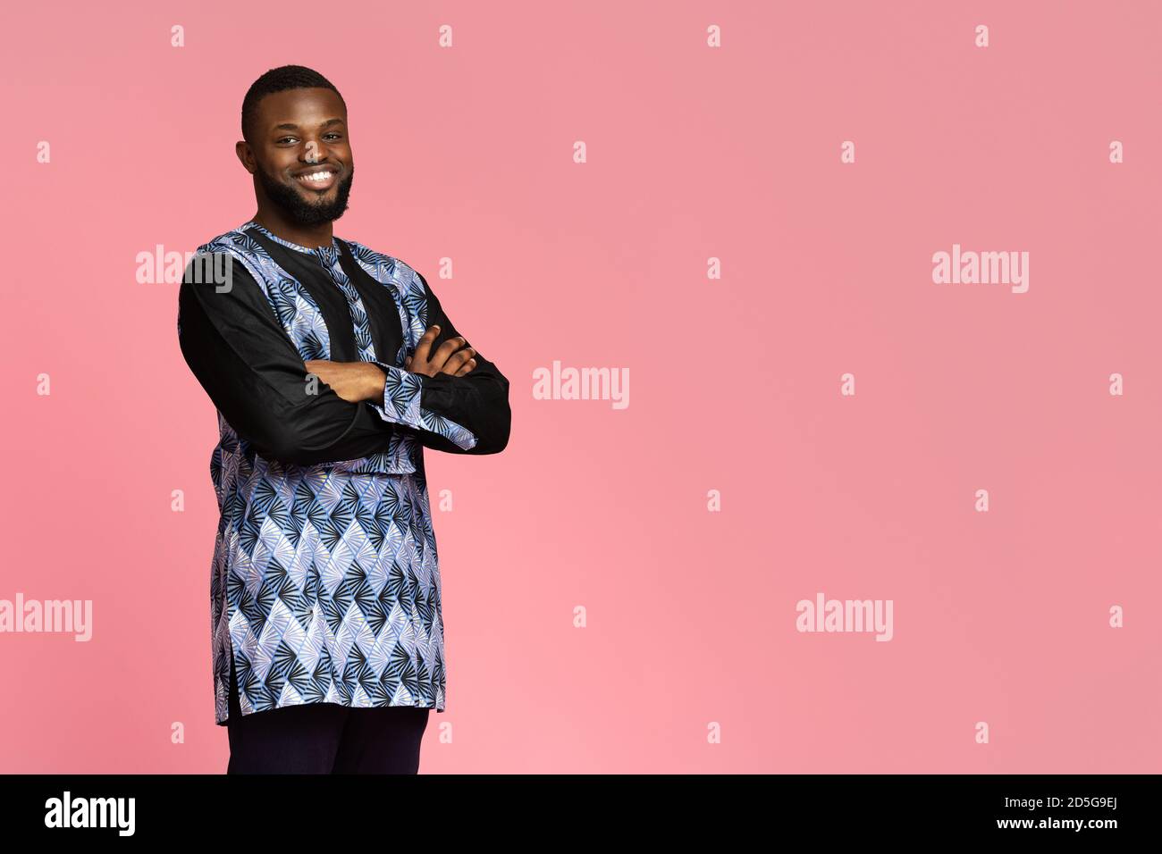 Smiling black man posing with arms crossed, free space Stock Photo - Alamy