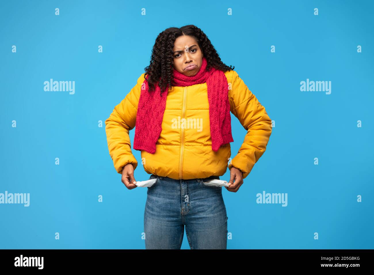 Sad African Woman Showing Empty Pockets Standing Over Blue Background ...
