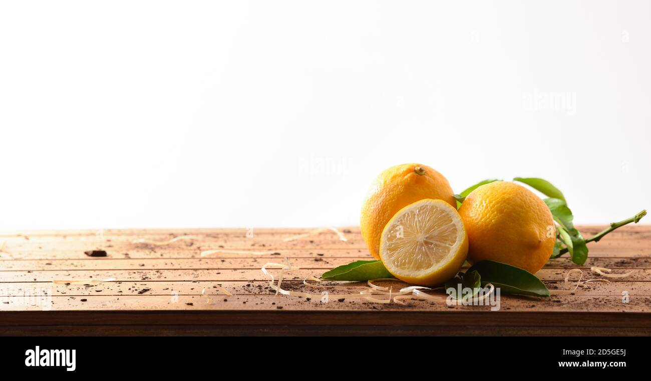 Harvest lemons on wooden table with white isolated background. Front ...