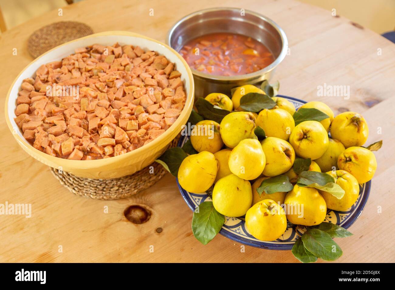 Bowls of quince fruit from garden and chopped fruits prepared for ...
