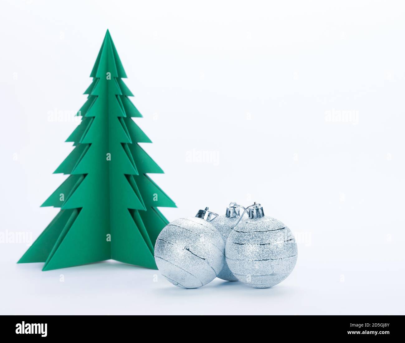 Christmas decorations and green paper tree on a white background Stock ...