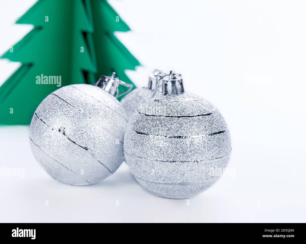 Christmas decorations and green paper tree on a white background Stock ...