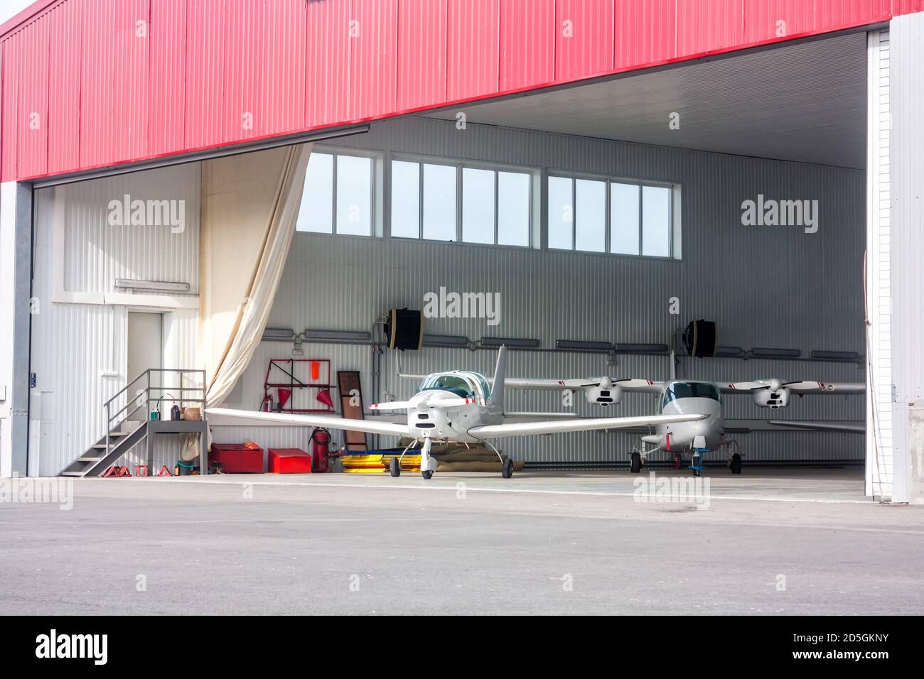 Small aircraft in open hangar Stock Photo - Alamy