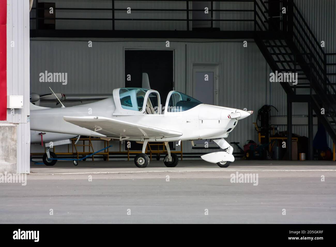 Small sports plane with opened cockpit canopy in the hangar Stock Photo ...