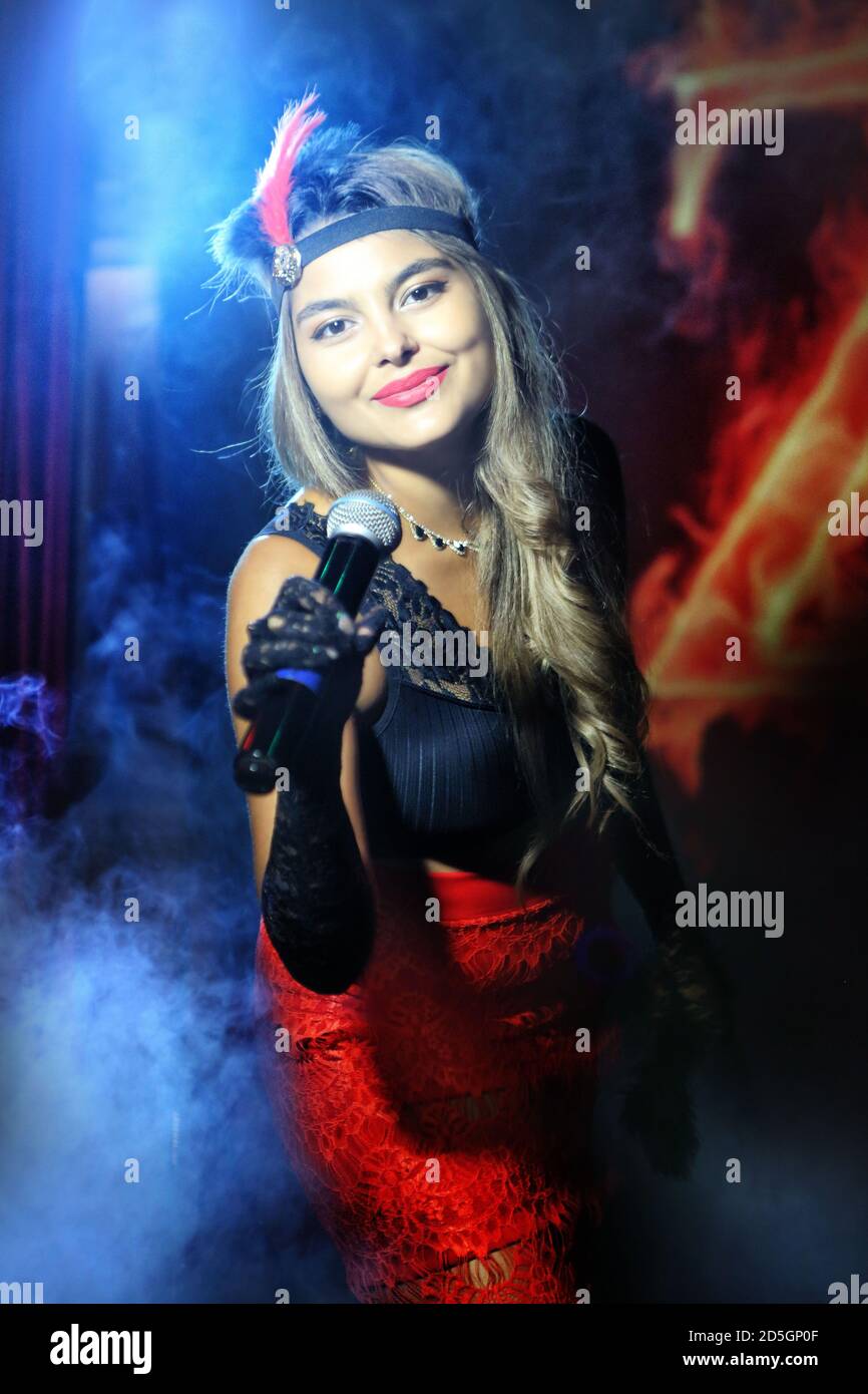 Girl with a microphone sings songs Stock Photo - Alamy