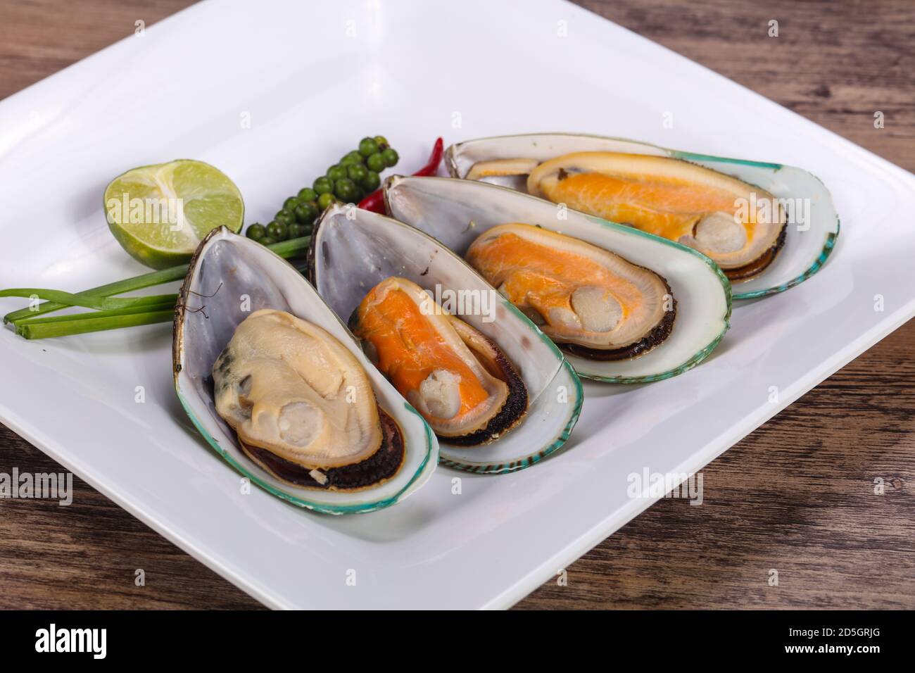 Half mussels with lime and green pepper Stock Photo - Alamy