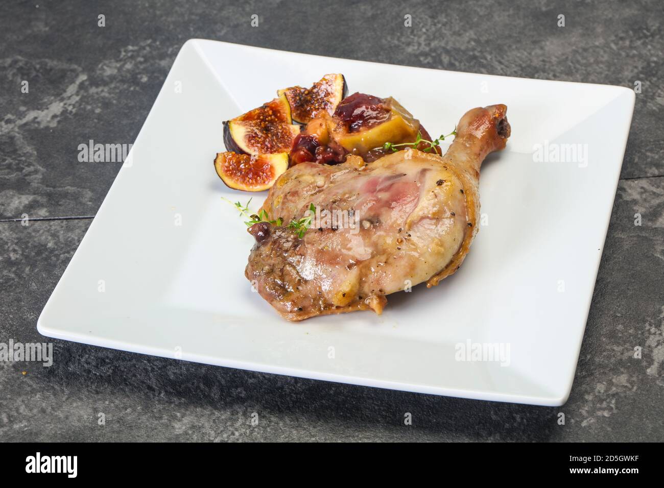 Roasted. duck. leg with plum, fig and apple Stock Photo - Alamy