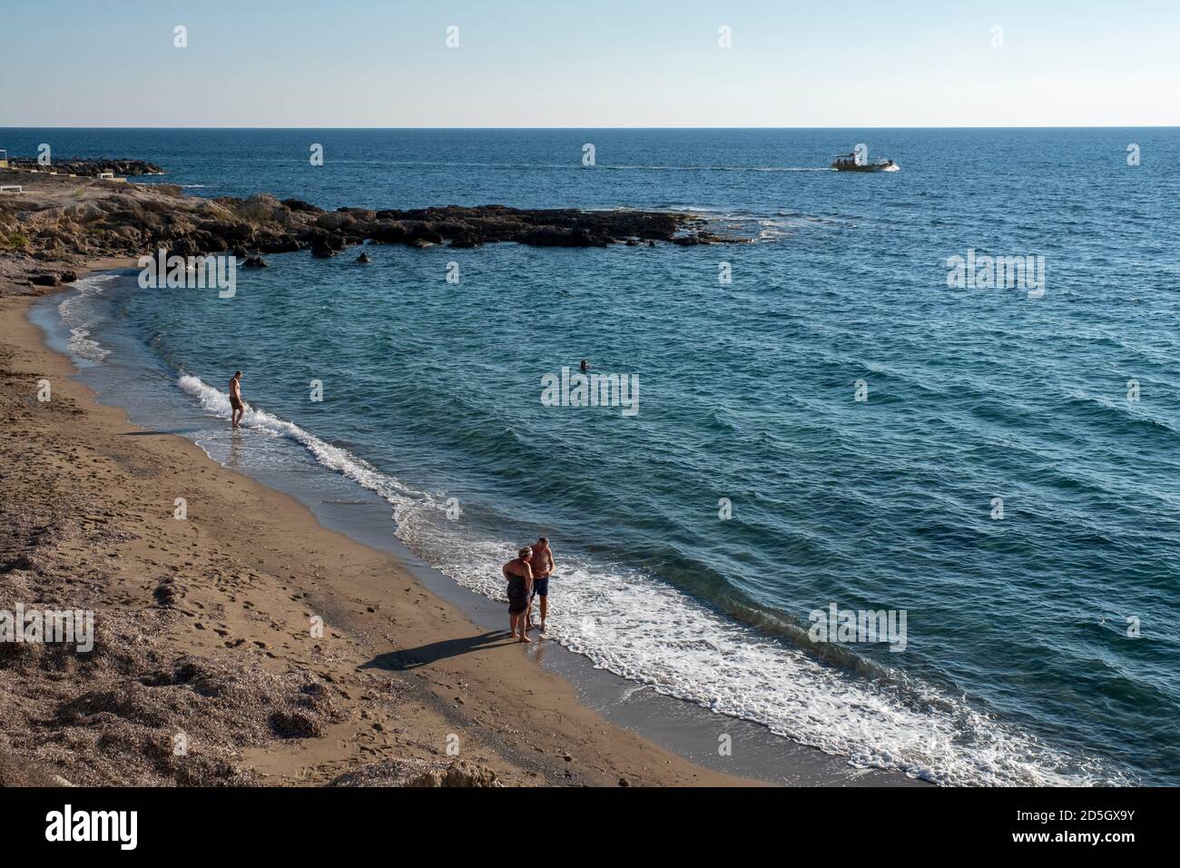 Tourists on a quiet sandy beach in Paphos, Cyprus Stock Photo - Alamy
