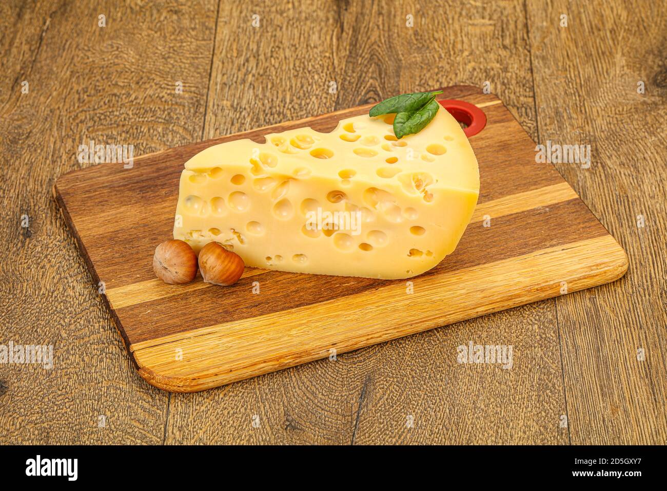 Maasdam cheese - dairy yellow triangle with holes Stock Photo - Alamy