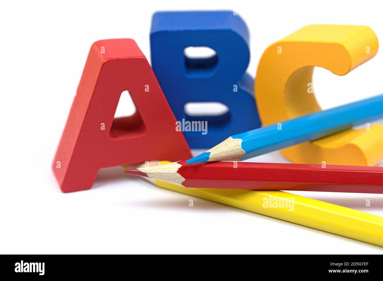 Wooden letters and colored pencils against a white background Stock ...