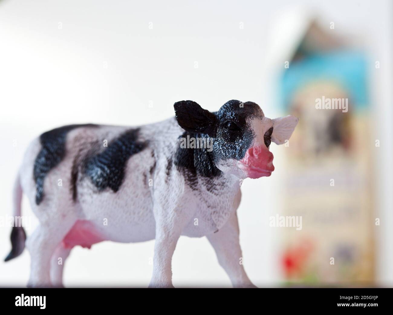 Miniature plastic cow with milk shot on white background Stock Photo ...