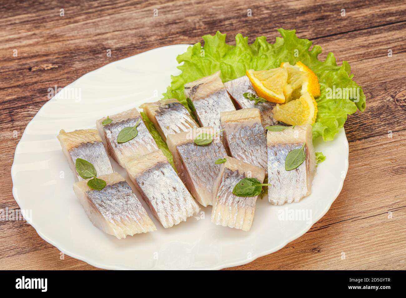 Marinated Herring fillet with sliced lemon Stock Photo - Alamy