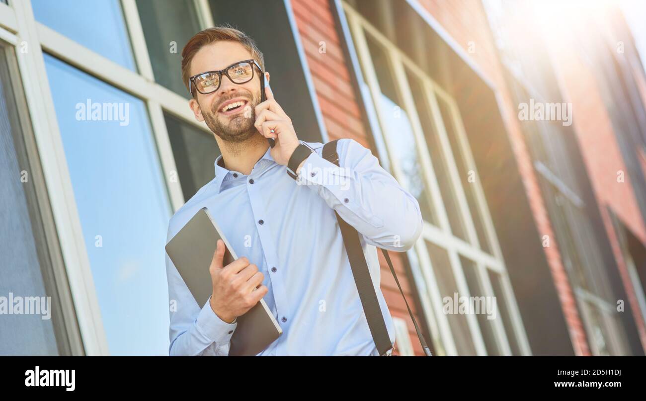 Good talk. Young happy caucasian businessman wearing blue shirt and ...