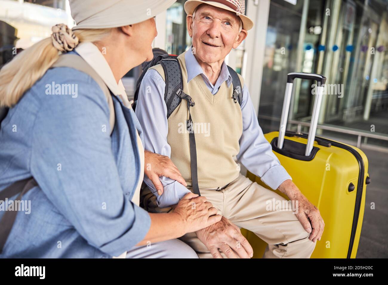 Two elderly Caucasian people sitting together outdoors Stock Photo - Alamy
