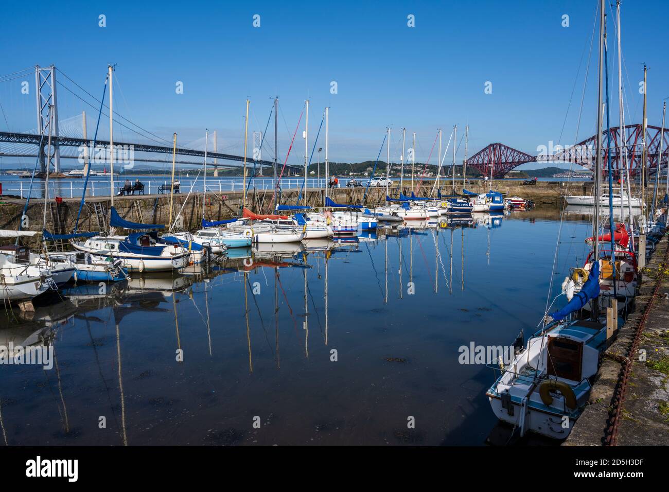 Colourful yachts moored in sheltered South Queensferry harbour with ...