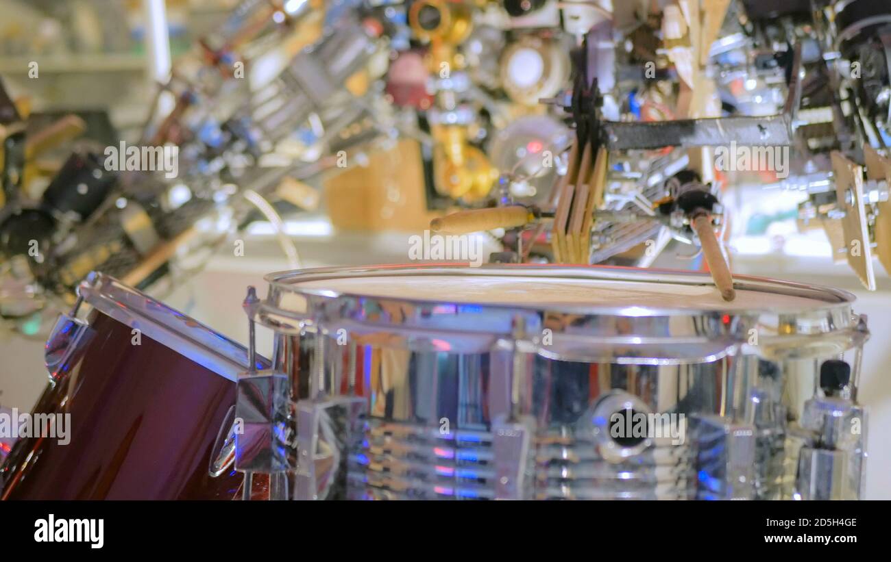 Vintage robot playing drums. Close up shot of robot hand with drumstick ...