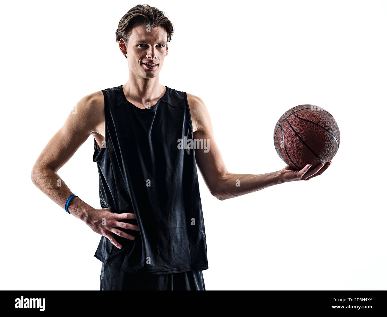 one caucasian basketball player man isolated in silhouette shadow on ...