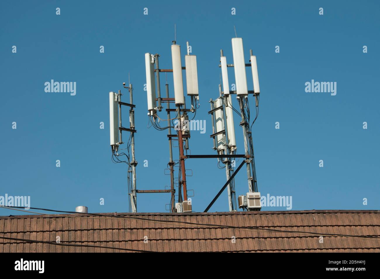 The cellular communication aerial on a building roof Stock Photo - Alamy