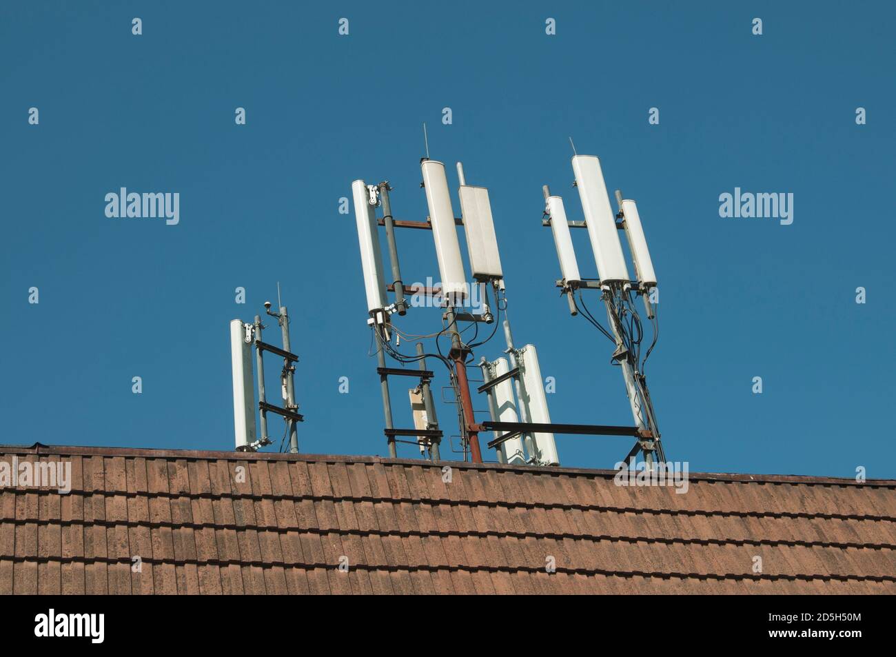 The cellular communication aerial on a building roof Stock Photo - Alamy