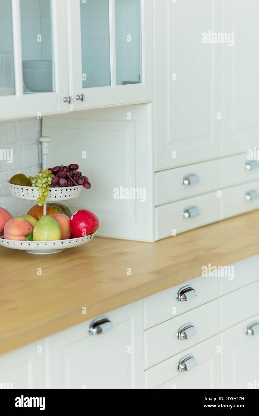 Fruit plate on the table in the modern classic white kitchen Stock ...