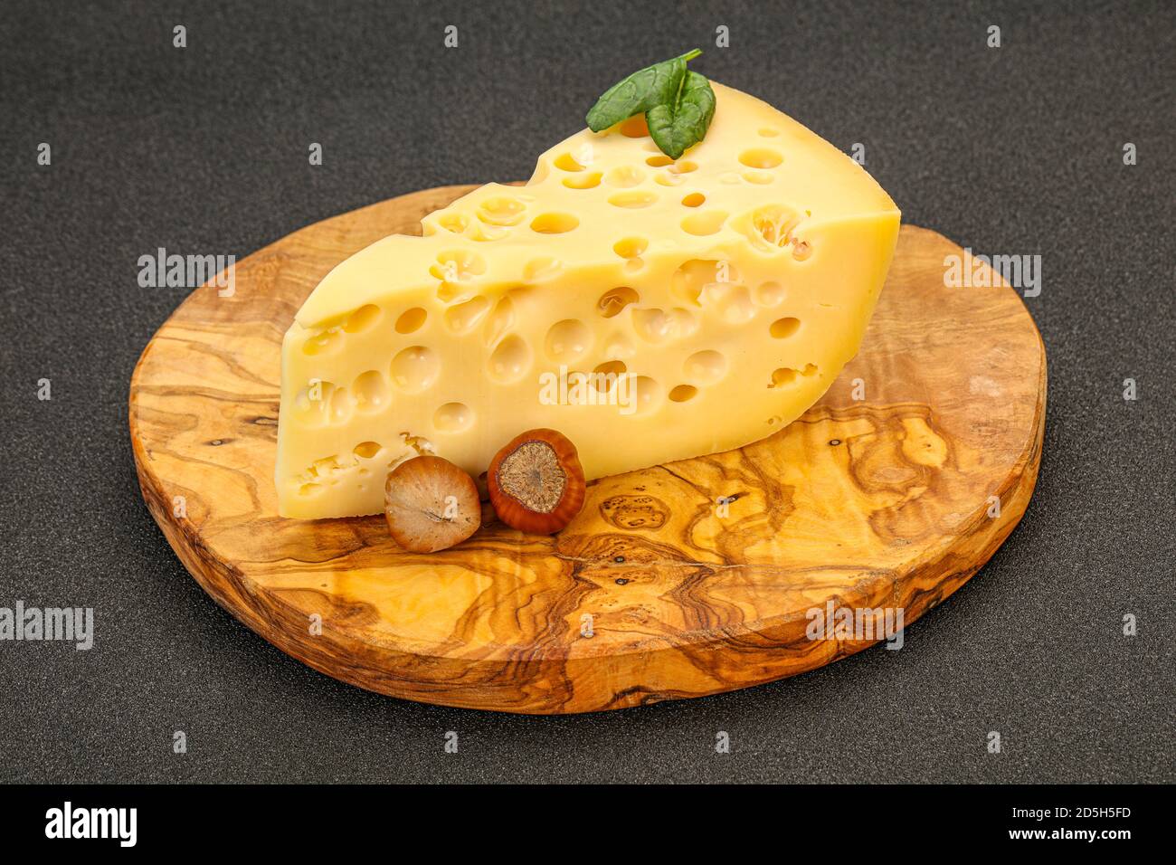 Maasdam cheese - dairy yellow triangle with holes Stock Photo - Alamy