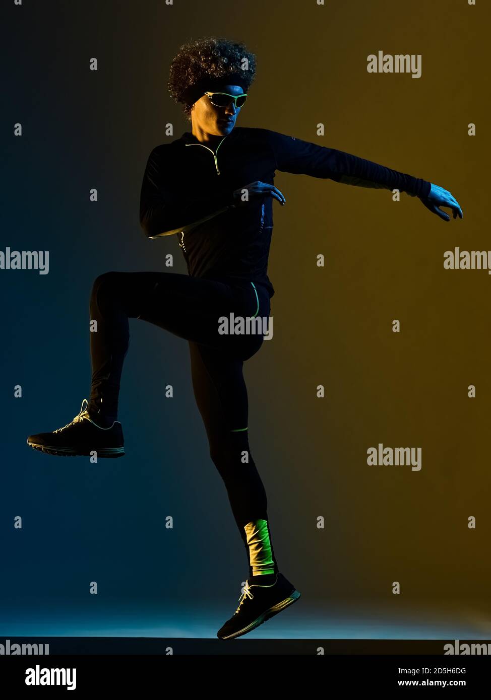 one youg caucasian runner jogger running jogging man in studio shadow ...