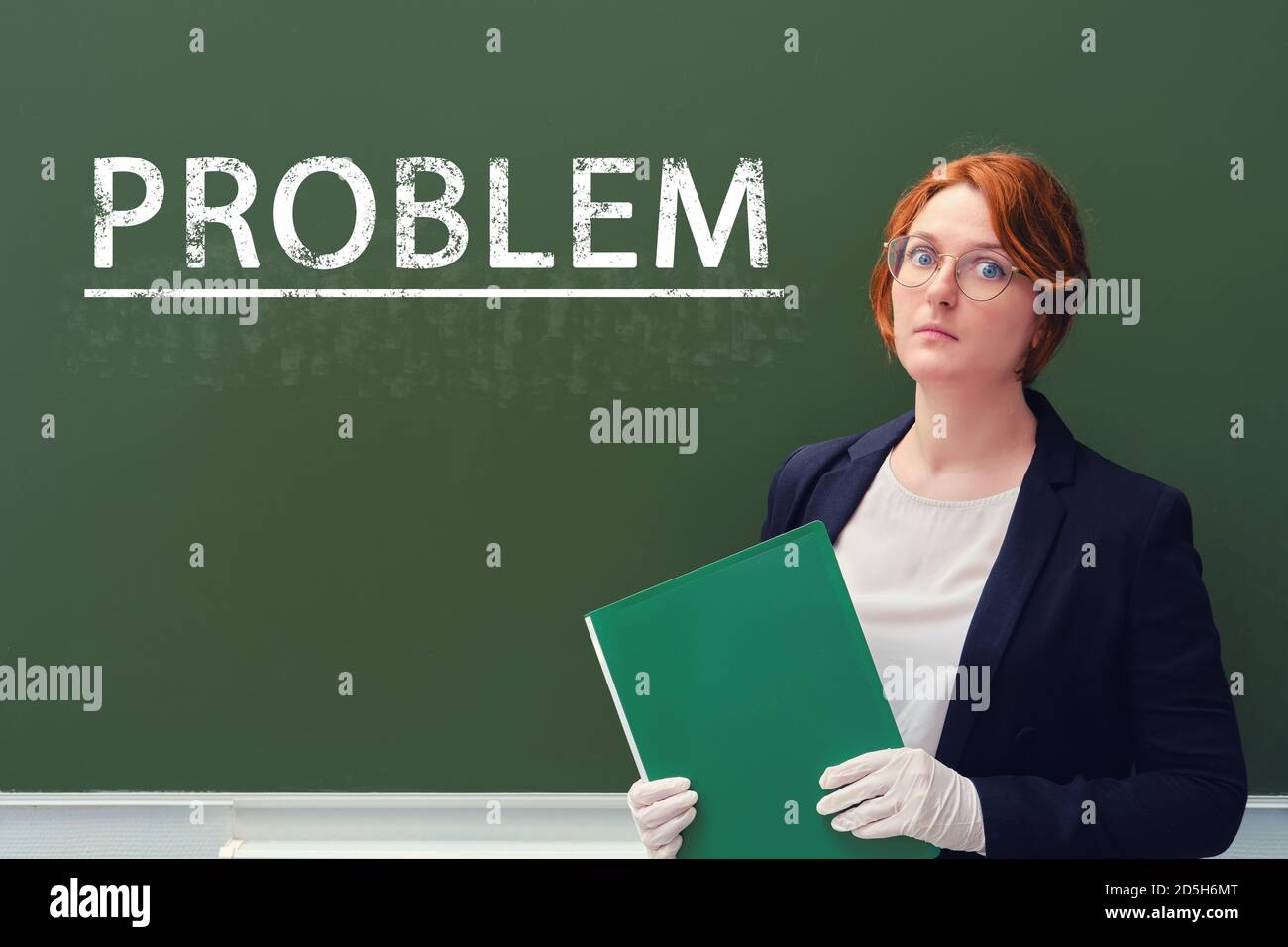 A woman teacher stands at the blackboard with the text "Problem ...