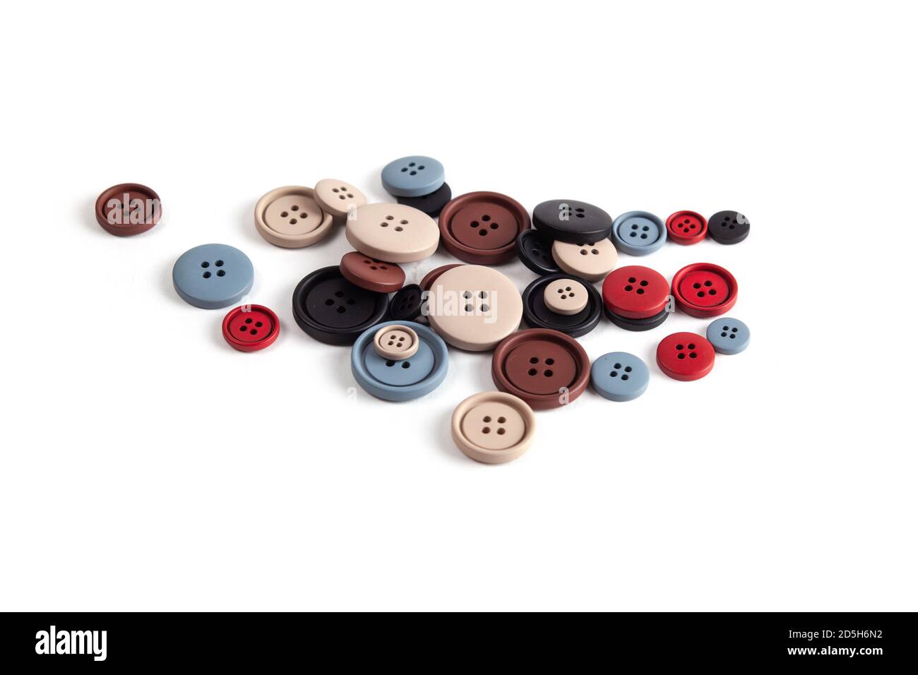 Pile of color brown, beige, grey, red, black plastic matte buttons on ...