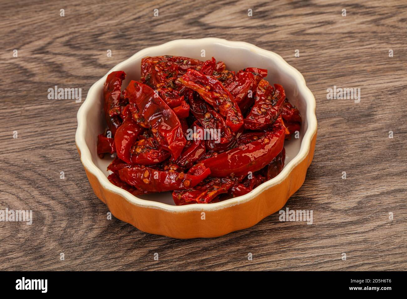 Dried tomato with olive oil and herbs Stock Photo - Alamy