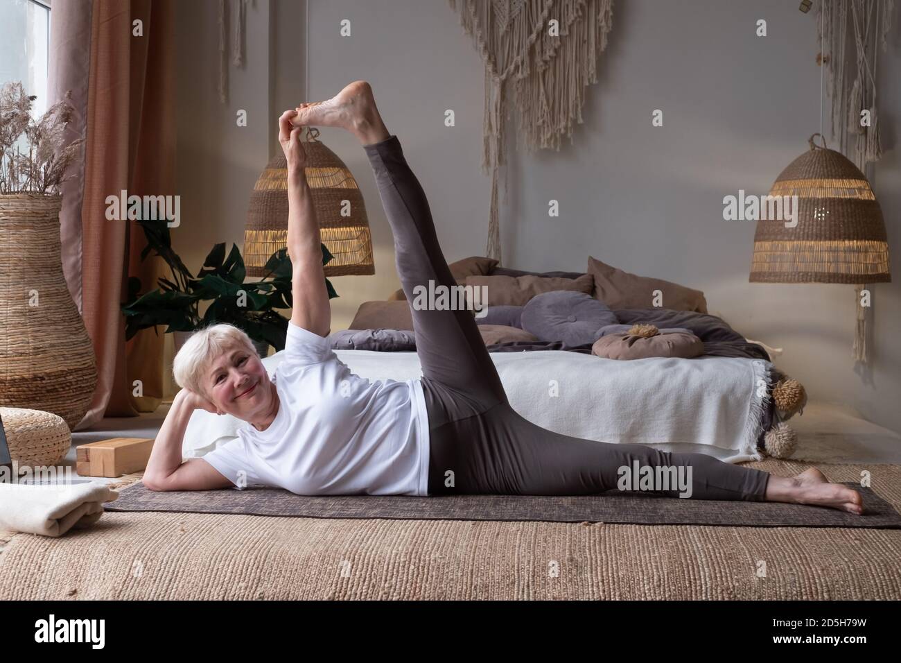 woman doing fitness workout, exercise stretching legs, Anantasana or ...