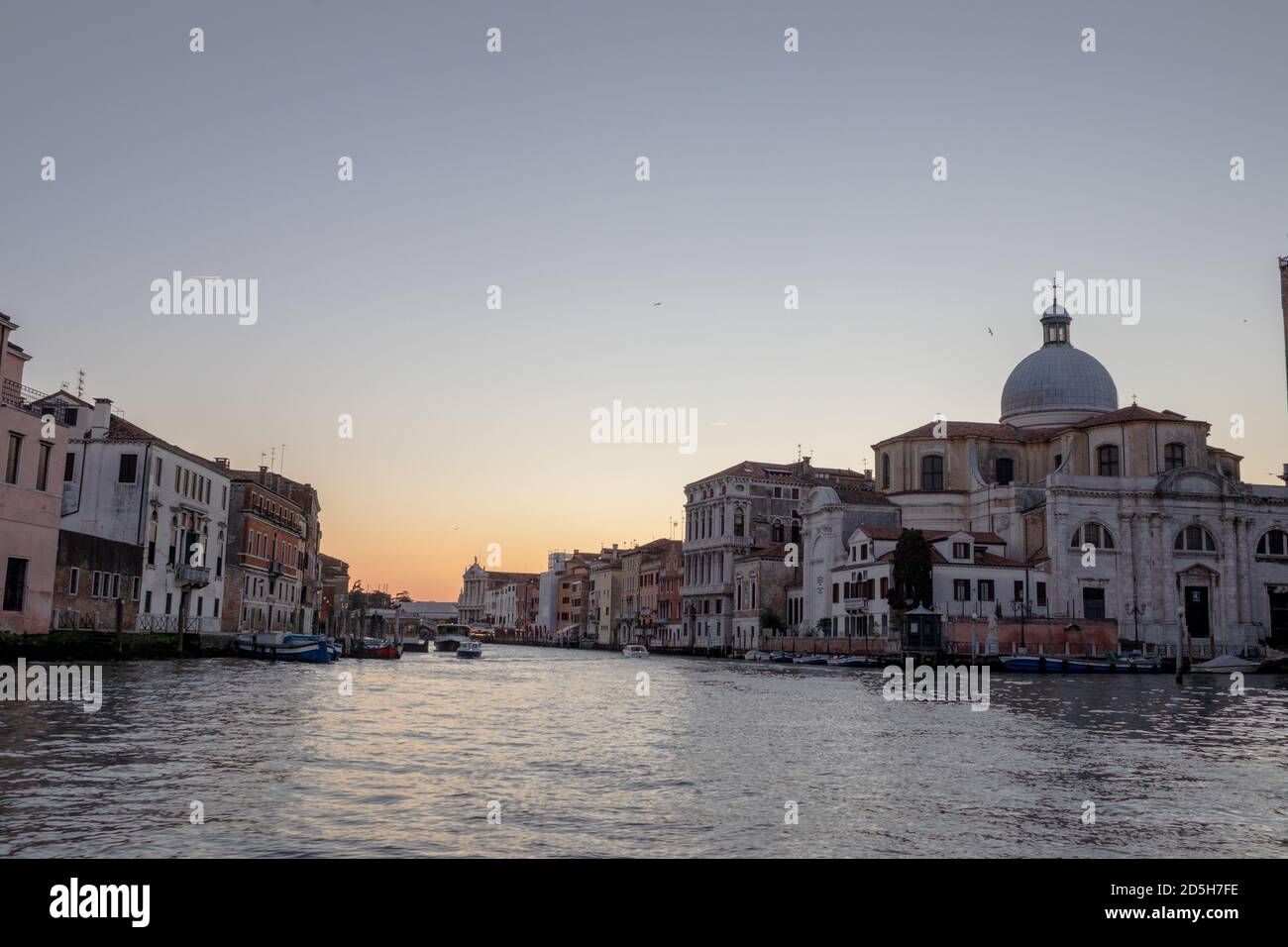 The setting sun creates a beautiful pastel evening sky over Venice ...