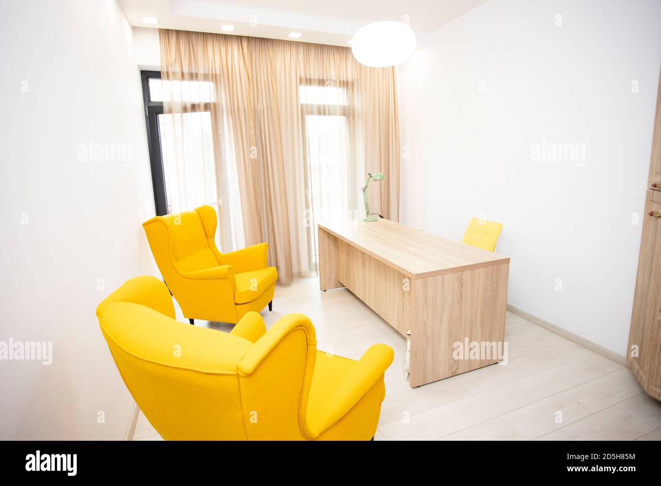 Chief executive or manager office with desk and armchairs, office ...